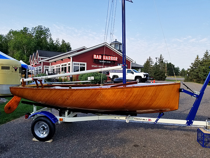 A wooden sailboat parked outside Bar Harbor&mdash;because in Minnesota, even the landlocked restaurants deserve a proper nautical entrance.