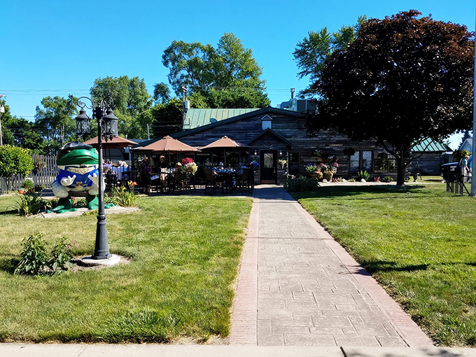 A wide-angle view showing the full approach to this woodland dining oasis. Those umbrellas aren't just for show&mdash;they're reserving prime real estate.