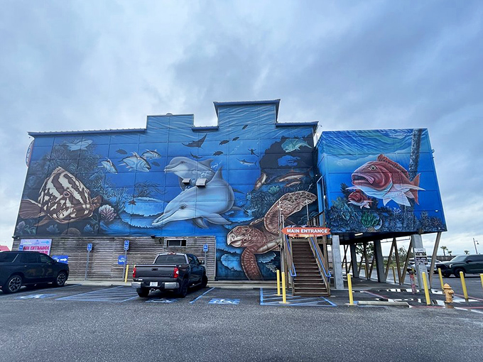 The Reef's exterior mural transforms a simple building into an underwater fantasy world, making you wonder if the fish inside are on the walls or on your plate.