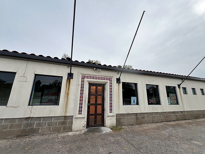 The unassuming exterior of Bedlam BAR-B-Q stands like a smoke-scented beacon of hope for hungry Oklahomans. That decorative tile entrance? Pure barbecue foreshadowing.
