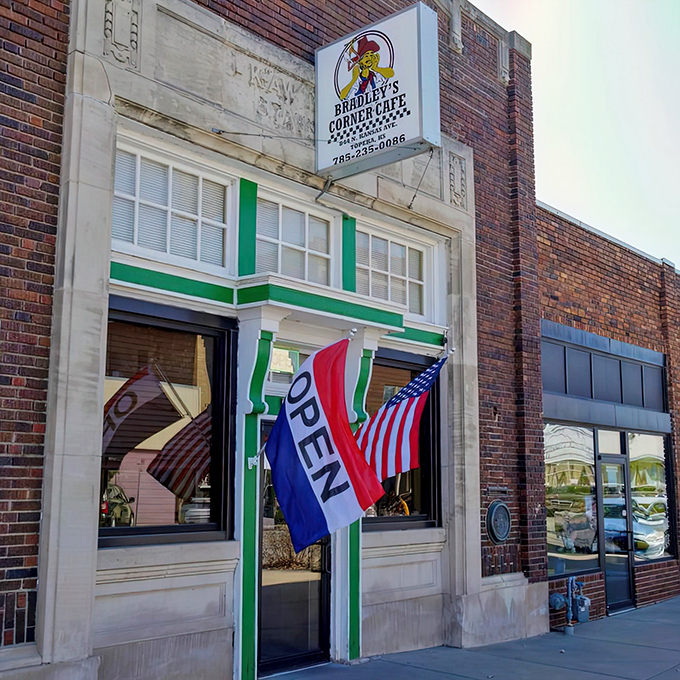 Bradley's Corner Cafe stands proudly in Topeka's NOTO district, its vintage sign and green-trimmed windows promising comfort food that delivers on nostalgia.