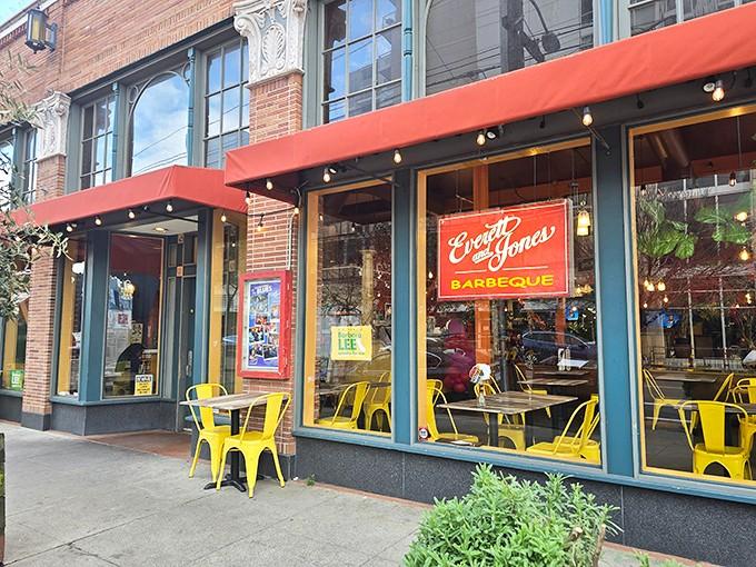 The iconic red and yellow signage of Everett & Jones beckons like a barbecue beacon on Broadway, promising smoky delights within.