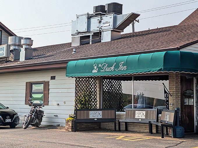 That green awning beckons like a lighthouse for hungry souls seeking supper club salvation in Delavan's heartland.