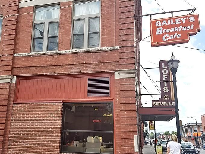 That cheerful red sign on the historic brick building promises breakfast excellence, and spoiler alert: it delivers every single time.