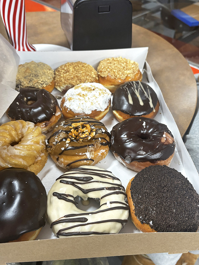 A dozen reasons to skip lunch. The white chocolate drizzle on that bottom donut is practically winking at you.
