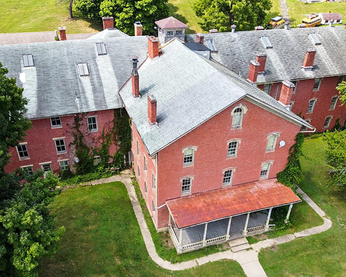 A bird's-eye view reveals the sprawling complex. The massive footprint of brick and slate roof tells of an era when institutions were built to last forever.