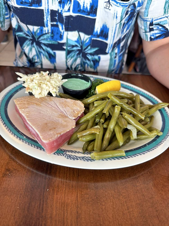 Seared ahi tuna showcasing that perfect pink center &ndash; proof that sometimes the best preparation is the one that respects the fish.