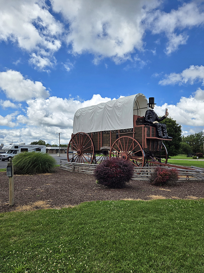 Blue skies provide the perfect backdrop for this wooden wonder. The landscaping adds a touch of domesticity to what would otherwise be pure roadside madness.