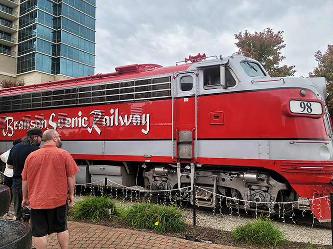 That gleaming red engine isn't just transportation; it's the mechanical heart of an experience that's been thrilling visitors for generations.