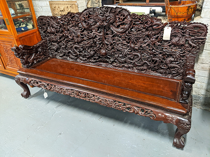This isn't just furniture; it's functional art. The intricate dragon carvings on this bench have tales to tell from another century.