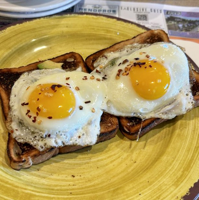 Sunny-side up eggs on toast &ndash; those perfect golden yolks just waiting to be broken, like tiny edible sunrises on your breakfast plate.