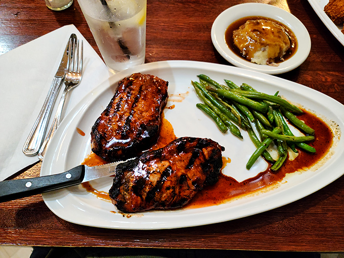These pork chops have clearly been introduced to fire and sauce in the most meaningful way possible. The green beans are there for moral support.