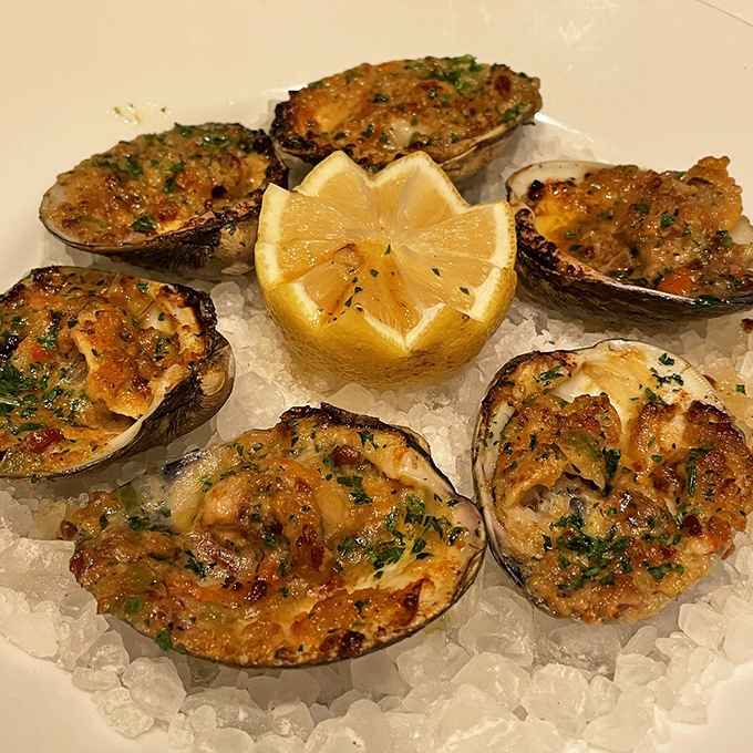 Baked clams that glisten with buttery goodness, arranged around a bright lemon star&mdash;seafood simplicity that lets the ocean's flavors shine through.