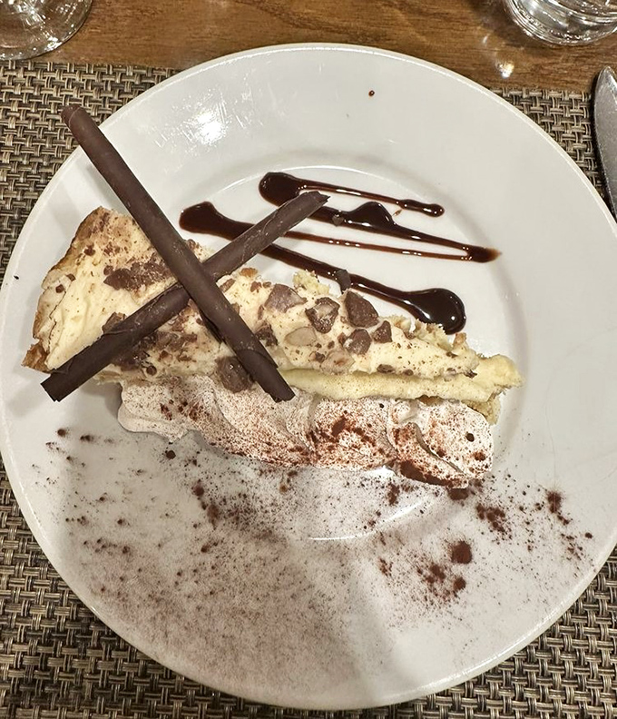 This dessert doesn't just end your meal, it punctuates it with chocolate accents and creamy filling that makes you reconsider the concept of "too full."