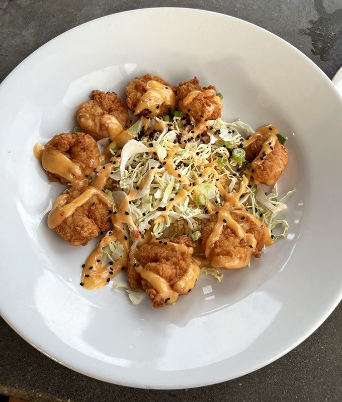 These Bang Bang Shrimp aren't just fried&mdash;they're transformed. Crispy morsels dancing around fresh slaw with a sauce that should be bottled and sold as happiness.