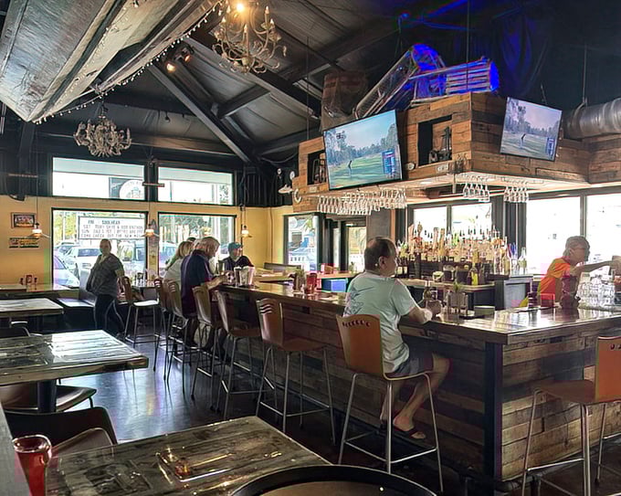 Where locals gather to swap fishing tales and food recommendations while bartenders orchestrate liquid happiness behind wooden fortifications.