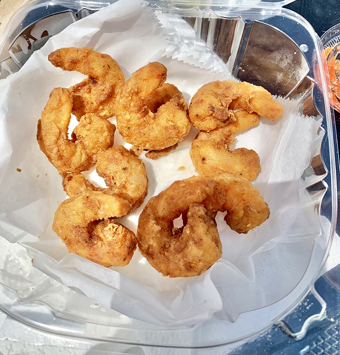 These golden-battered shrimp aren't just food—they're little crescents of happiness that make you forget your troubles.
