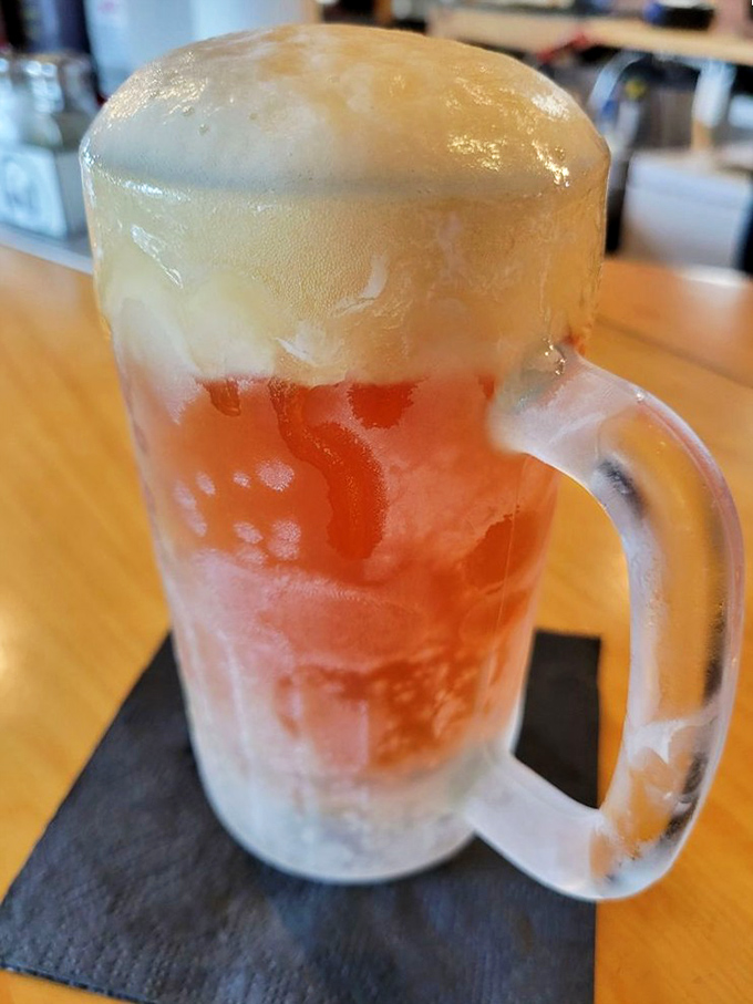 A frosty mug of beer with that perfect foam cap&mdash;because sometimes the best barbecue wingman comes in liquid form.