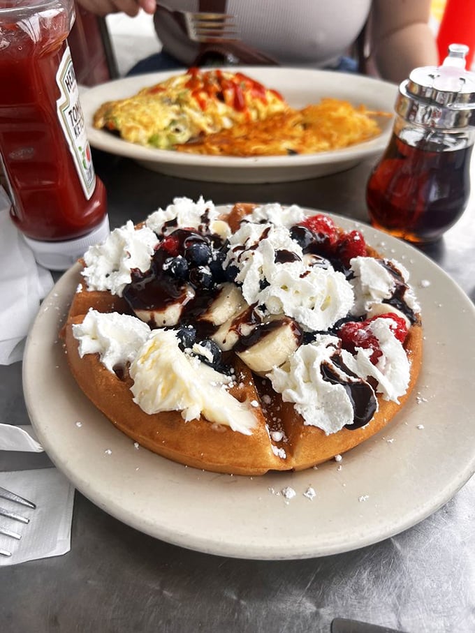 This Belgian waffle topped with fresh fruit, whipped cream, and chocolate sauce proves that sometimes more is exactly the right amount.