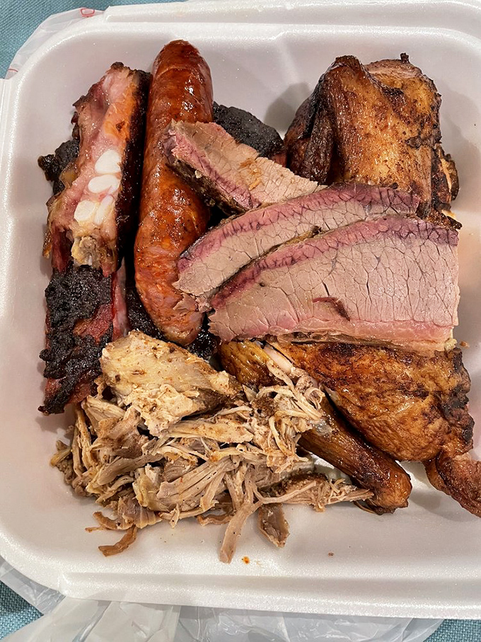 The BBQ trinity &ndash; brisket with that pencil-thin smoke ring, sausage with snap, and pulled pork that's clearly been introduced to smoke properly.