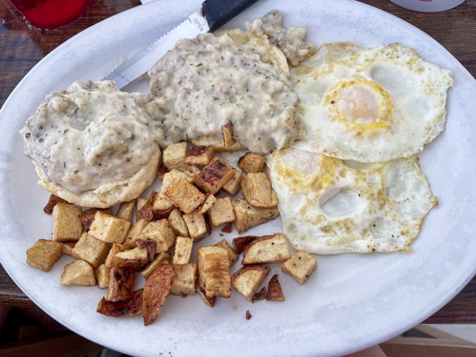 Biscuits and gravy with sunny-side eggs—the breakfast equivalent of winning the lottery while wearing comfortable pants.