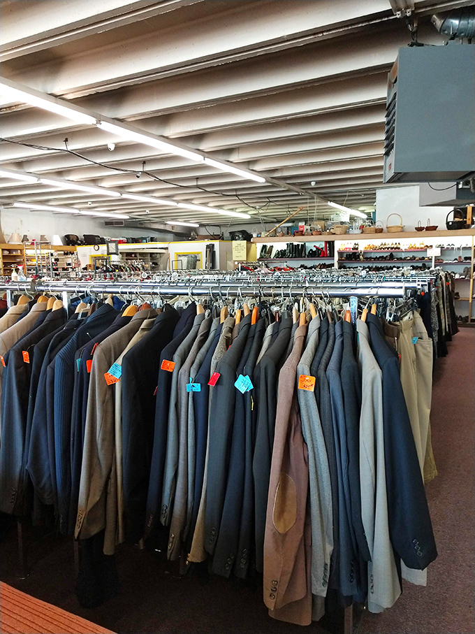 Men's suits and blazers stand at attention, ready for their second act in someone's professional wardrobe or quirky costume collection.