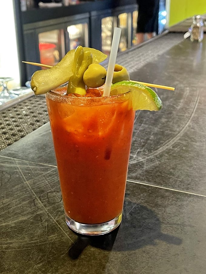 The Bloody Mary arrives garnished like it's ready for battle&mdash;pickles and olives standing at attention. Breakfast, lunch, and courage in one glass.