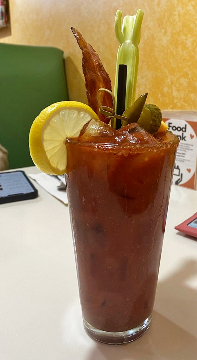 A Bloody Mary garnished with what appears to be half the appetizer menu. That bacon strip is basically a cocktail bonus prize.