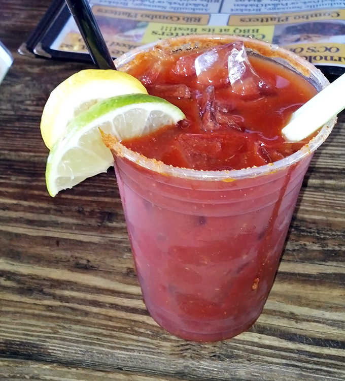 A bloody mary garnished with lime that looks refreshing enough to make you forget you're supposed to be focusing on crabs.