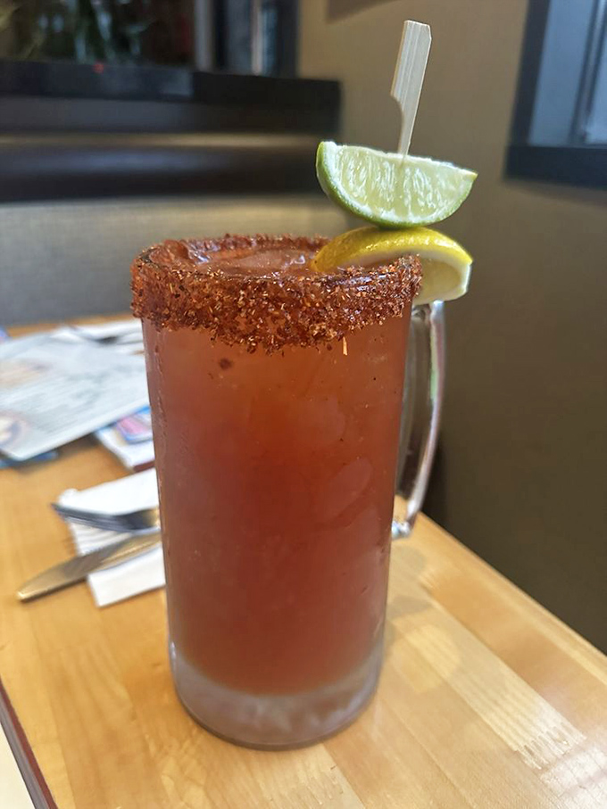 The Bloody Mary arrives with a spicy rim and citrus garnish, standing tall like a morning cocktail superhero ready to rescue your weekend.