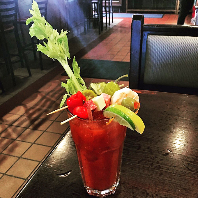 A Bloody Mary that's practically a meal, accessorized better than a fashion influencer. That celery stalk is just showing off.