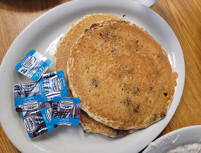 Blueberry pancakes the size of small frisbees, ready to soak up maple syrup like they've been training for this moment.
