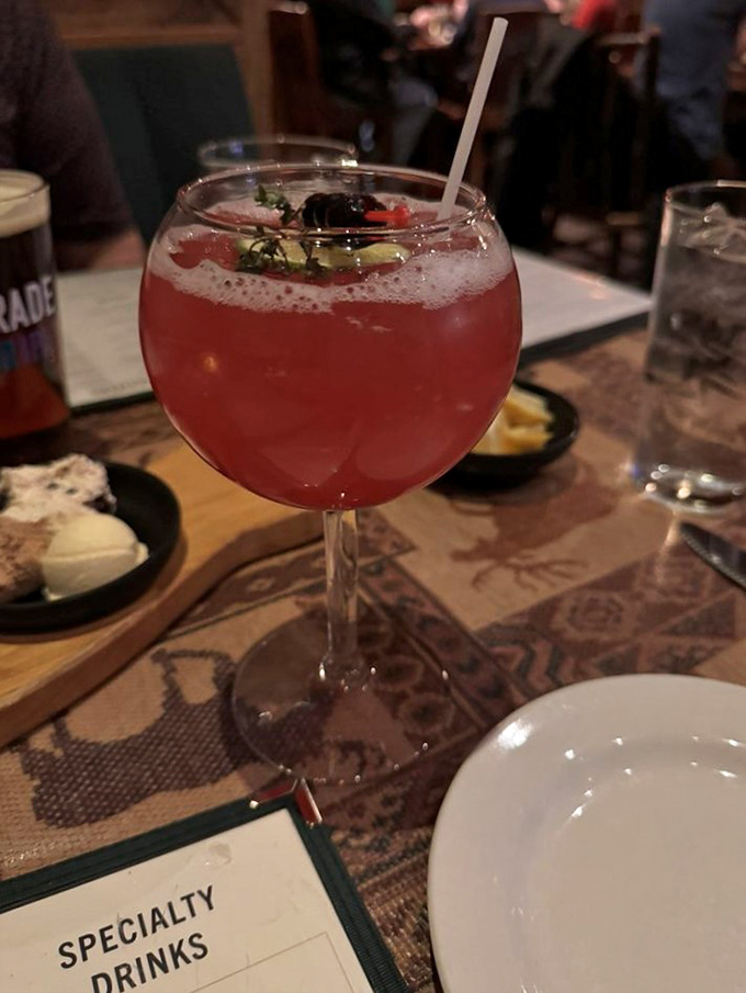This vibrant cocktail isn't just a drink; it's summer captured in a glass, complete with fresh berries and herb garnish.