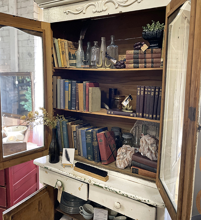 A bibliophile's dream corner! Vintage books and antique bottles create the perfect vignette for anyone who judges rooms by their literary offerings.