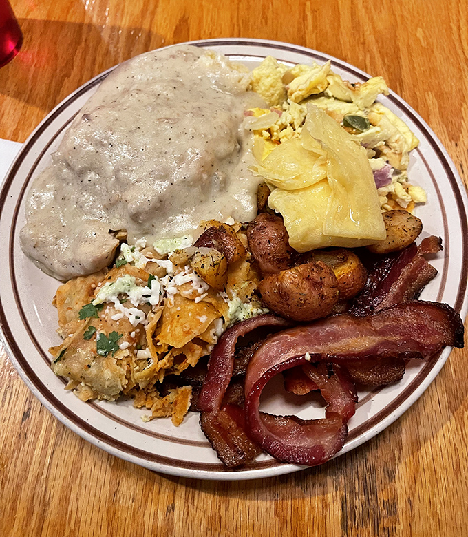 Breakfast done right &ndash; eggs, bacon, and potatoes having a delicious morning meeting on your plate.