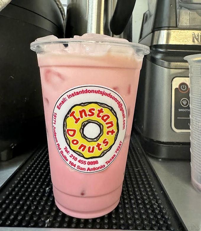 Pink bubble tea proving that even drinks want to match the cheerful walls in here.