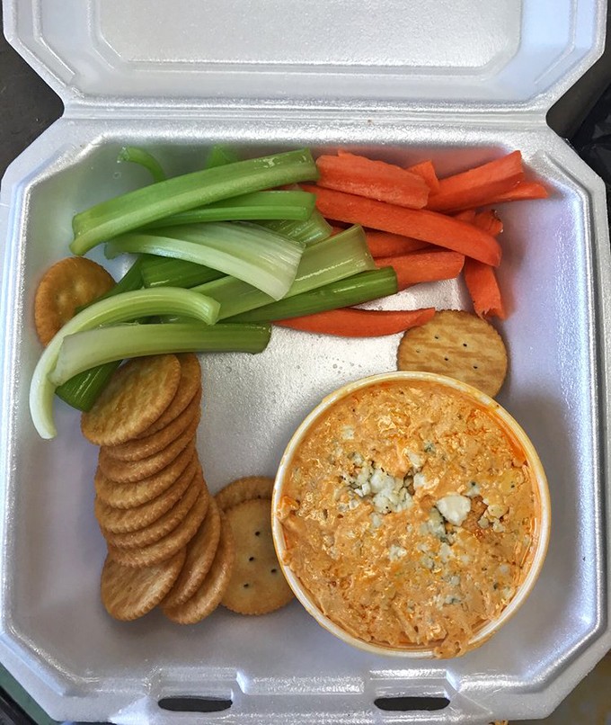 Buffalo chicken dip with a proper veggie-to-cracker ratio. The kind of appetizer that makes you wonder why you bothered ordering a main course.