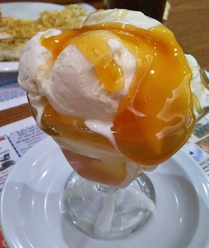 Ice cream and butterscotch sauce performing their sweet duet in a parfait glass&mdash;a timeless dessert that whispers, "Diet? What diet?"