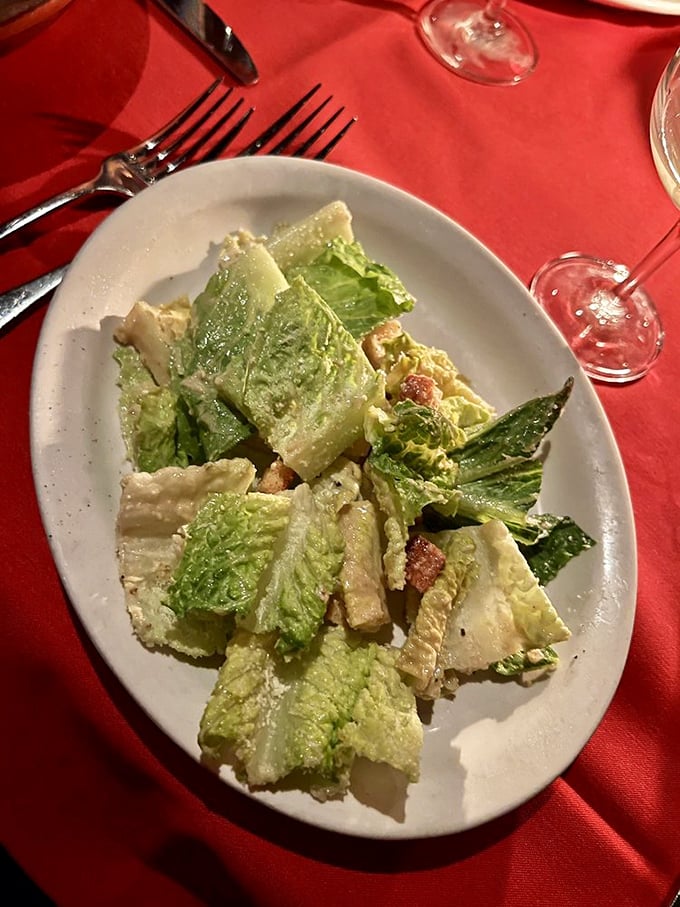 Caesar salad prepared tableside with the theatrical flair of a Vegas magic show, minus the smoke machines.