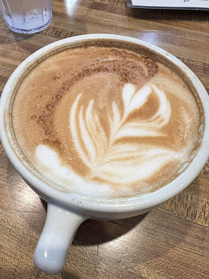 Latte art so pretty you almost don't want to drink it. Almost. That leaf design is practically begging for its Instagram moment.