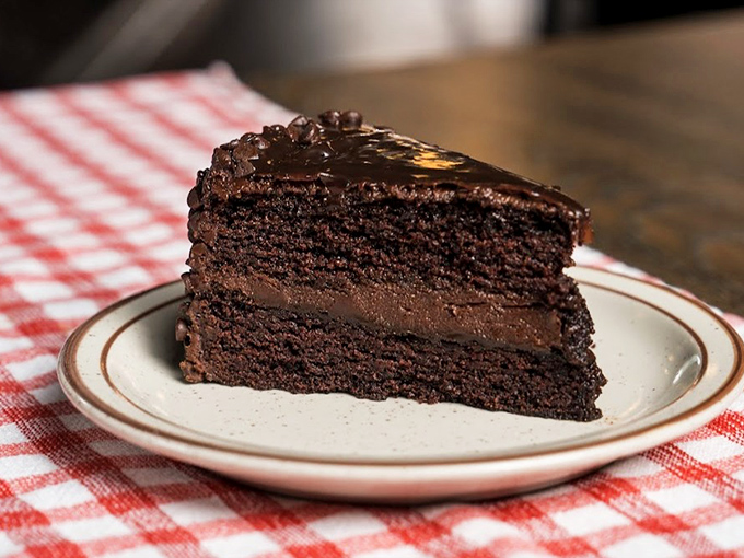 Chocolate cake so rich it probably owns real estate in three states. That filling looks like it's plotting to take over the world.