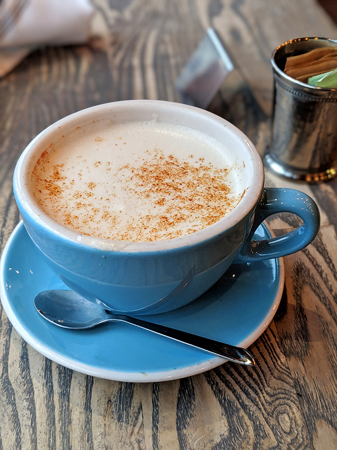 This isn't just coffee&mdash;it's a blue ceramic cup of morning motivation, dusted with cinnamon and served with a side of "now I can face the day."