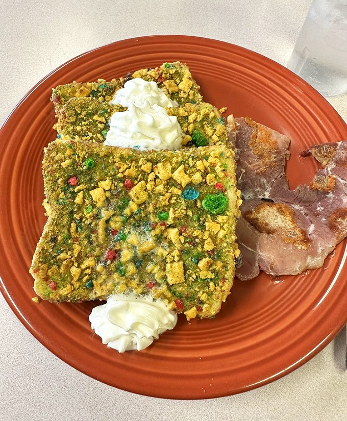 Captain Crunch French toast that transforms childhood cereal memories into grown-up breakfast indulgence, complete with whipped cream islands.