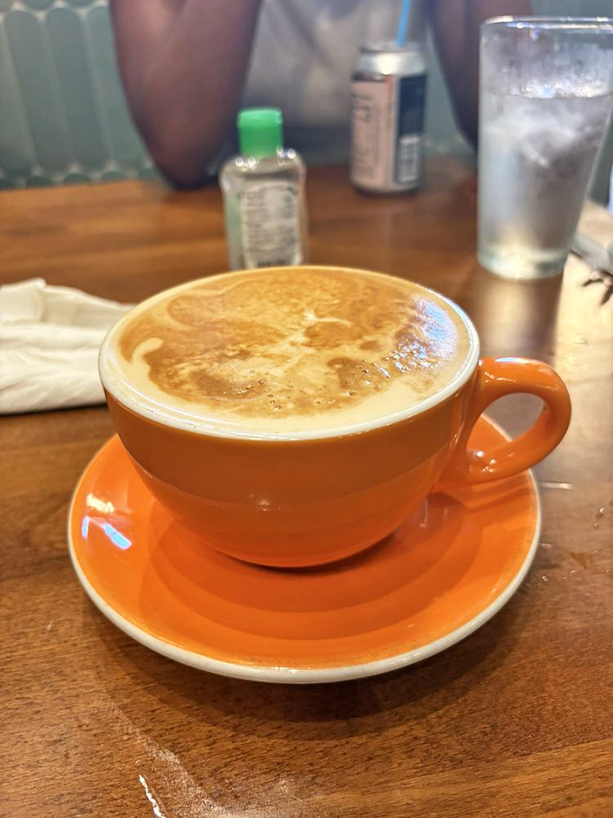 That bright orange cup filled with perfectly crafted latte suggests the coffee game here is just as strong as the food lineup.