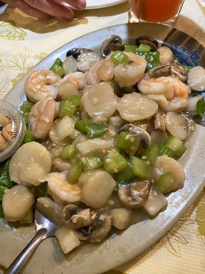 Plump shrimp, tender scallops, and crisp vegetables swimming in a delicate sauce—seafood that tastes like it just jumped from ocean to wok.