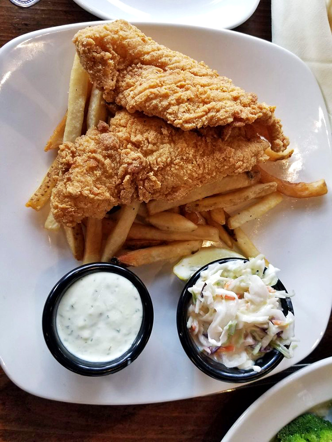 Crispy catfish and fries stacked like a golden Jenga tower &ndash; one wrong move and you'll be forced to eat another delicious piece.