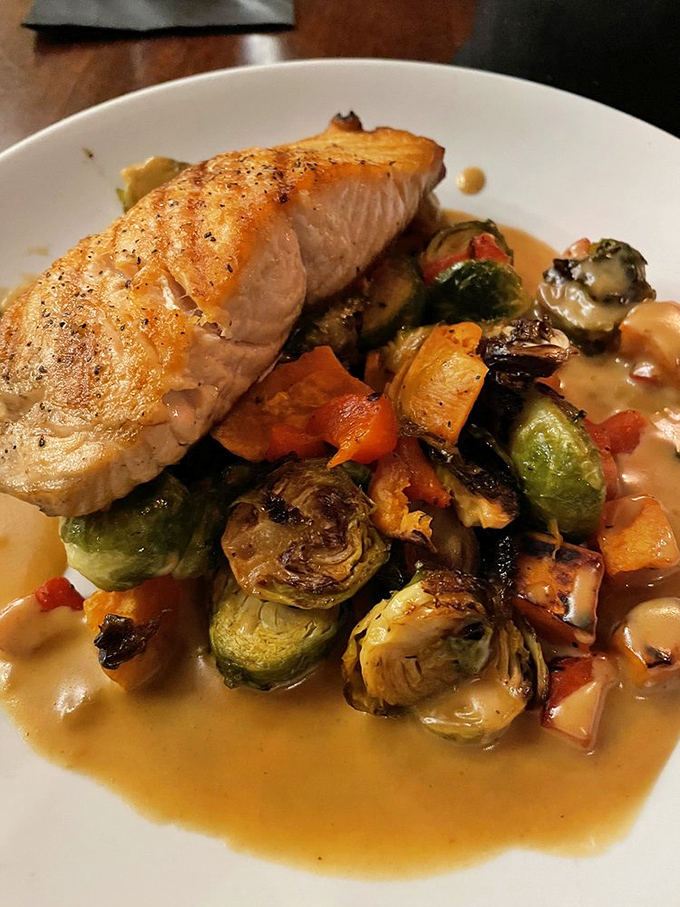 Cedar-planked salmon that's not just cooked &ndash; it's been given a spa treatment of roasted vegetables and a buttery sauce bath.