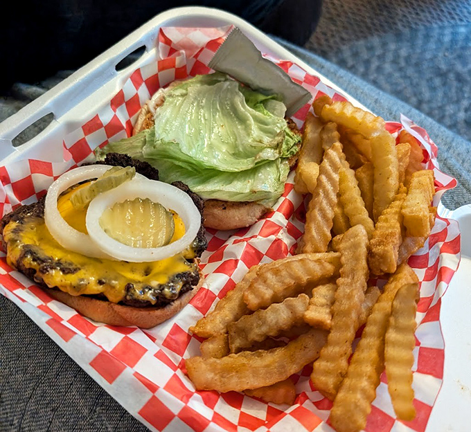 The burger that launched a thousand napkins. Melted cheese cascades over a hand-patted patty with perfectly golden crinkle-cut fries.