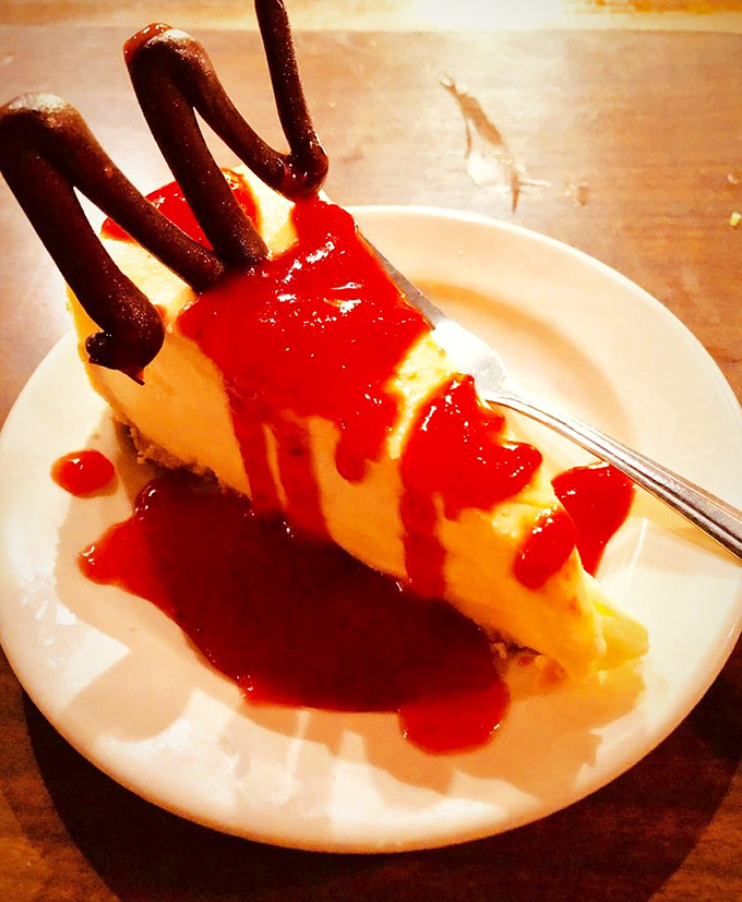 This cheesecake doesn't just have a chocolate garnish—it has architecture that demands respect before the first heavenly bite.