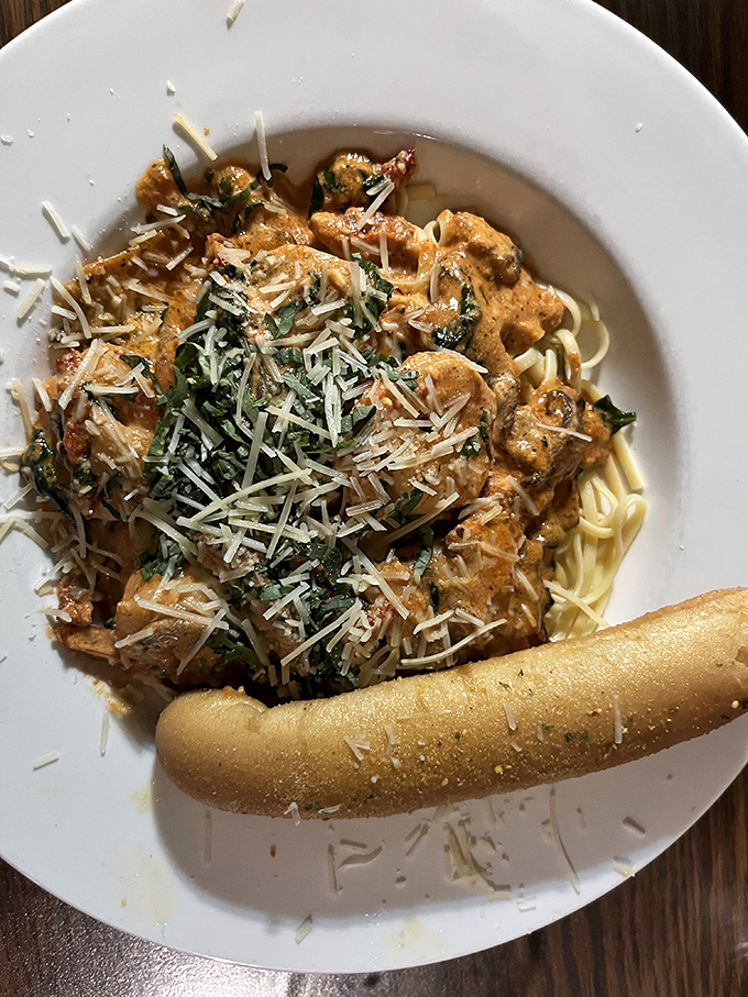 Pasta that hugs its sauce like long-lost friends at a reunion, topped with enough cheese to make Wisconsin proud.
